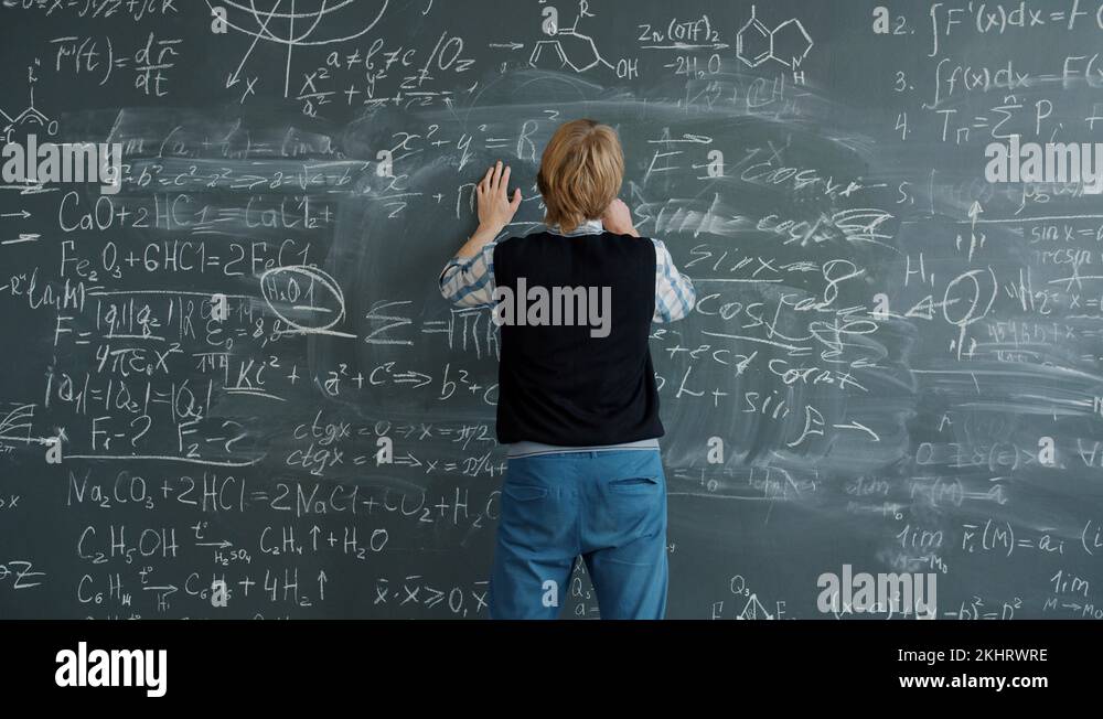 Portrait of unhappy teacher writing on board then leaving when students ...