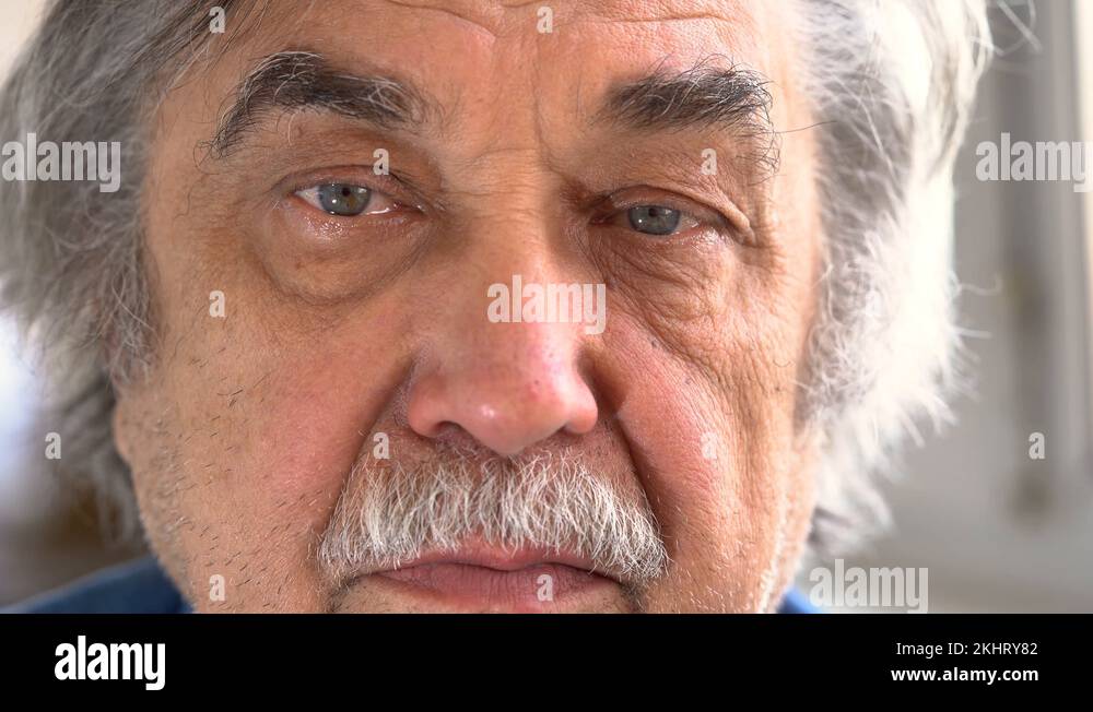 Baby boomer old man calmly and kindly looks at the camera Stock Video ...
