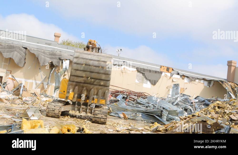 Heavy construction equipment picks up metal at demolition site C Stock ...