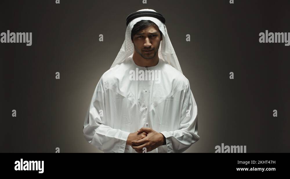 Bearded angry arab man looking at camera and threatening with a fist ...