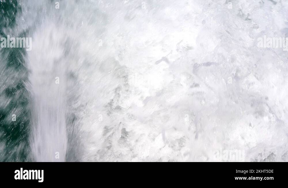 Close up of Blue Ocean sea water with wake foam of prop wash from speed ...