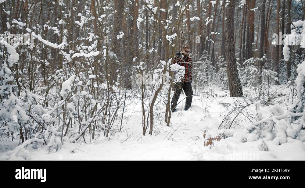Bearded man walking among pine trees with axe Stock Video Footage - Alamy