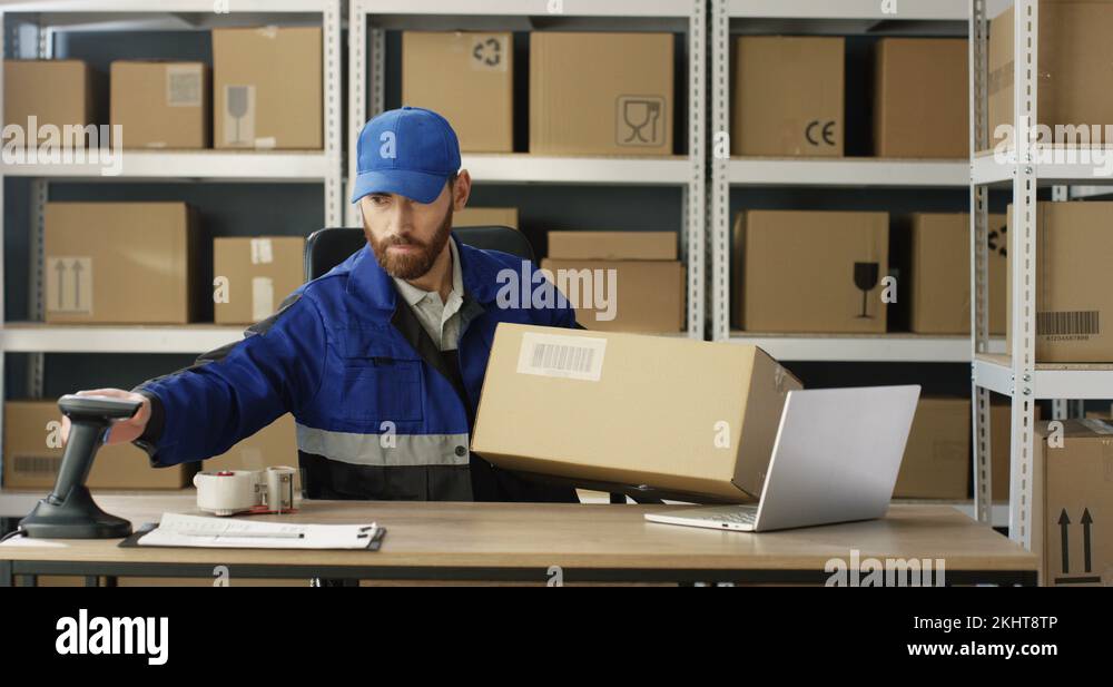 Caucasian handsome postman in uniform working in post office. Male ...