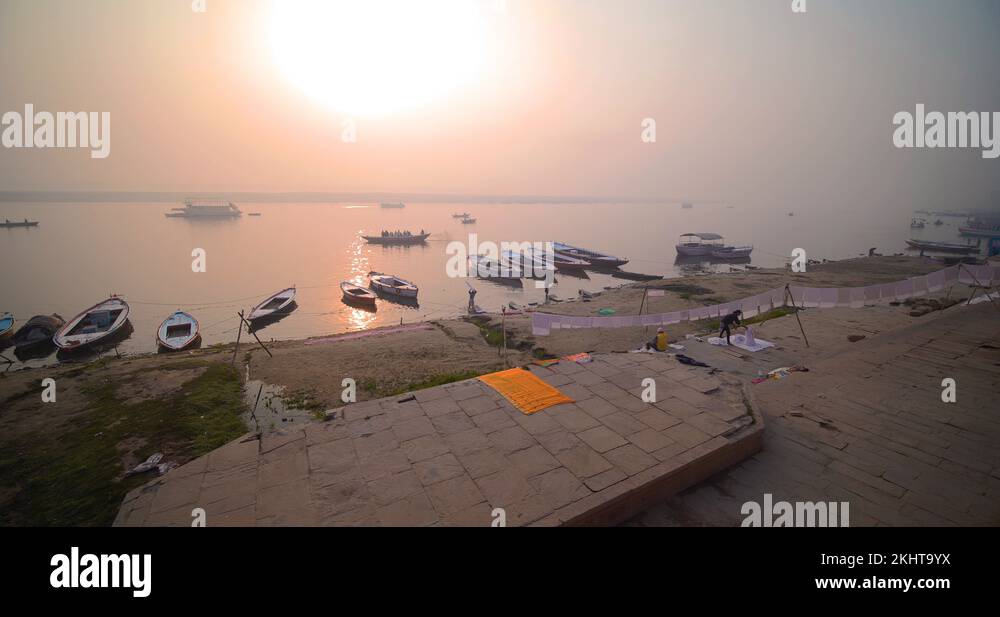 people washing clothes in polluted Ganges river and drying in Varanasi ...