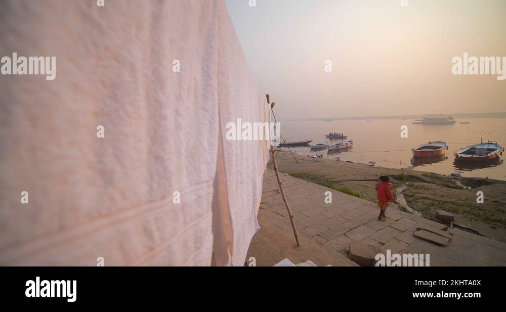 people washing clothes in polluted Ganges river and drying in Varanasi ...