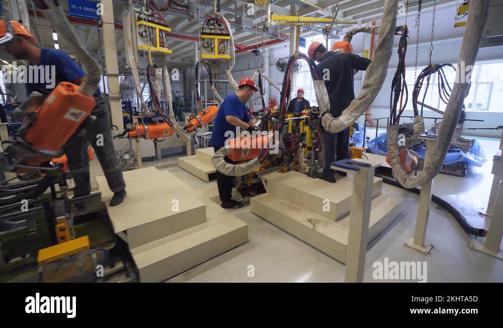 Automobile plant, modern production of cars, workers assemble the body ...