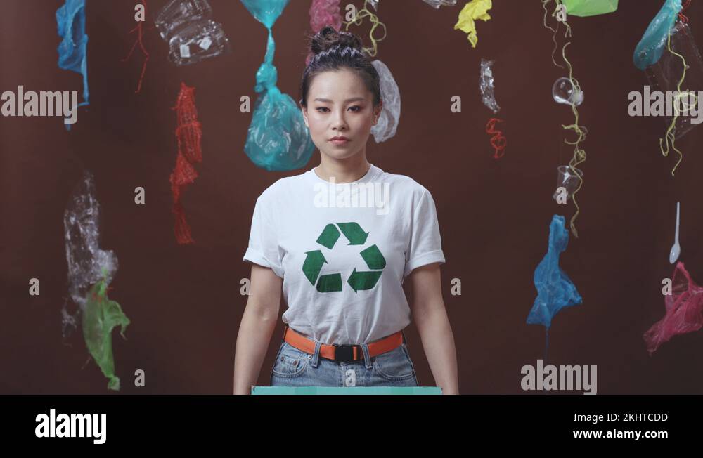 Young Asian woman ecology activist showing an invocatory eco poster on ...