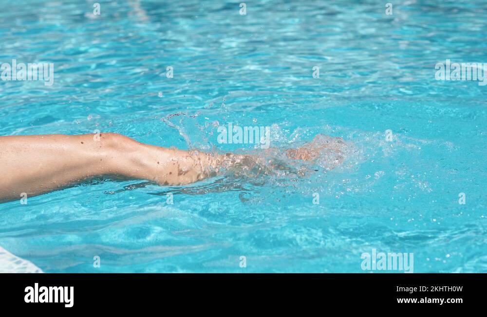 female legs dipping in water in swimming pool Stock Video Footage - Alamy