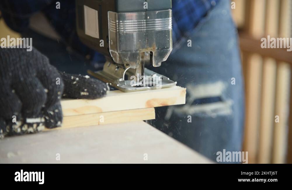 Carpenter man worker using electric hand saw cutting wood plank Stock ...
