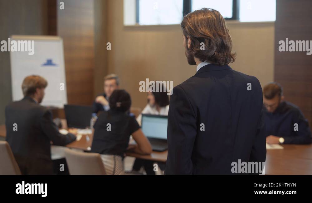 international business meeting, young man stands in conference room and ...