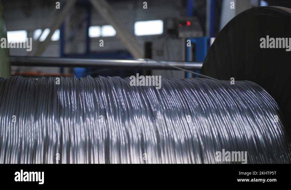 Aluminum wire pulley rolling. Winding the aluminum cable onto the reel ...