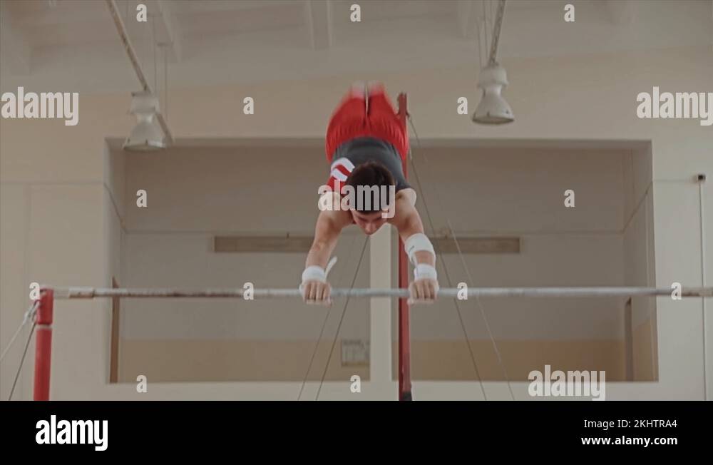 Gymnast performs exercises on uneven bars. Beautiful sport. A healthy ...