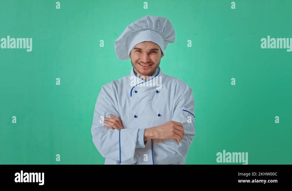 Green background charismatic baker guy in the uniform of baker posing ...