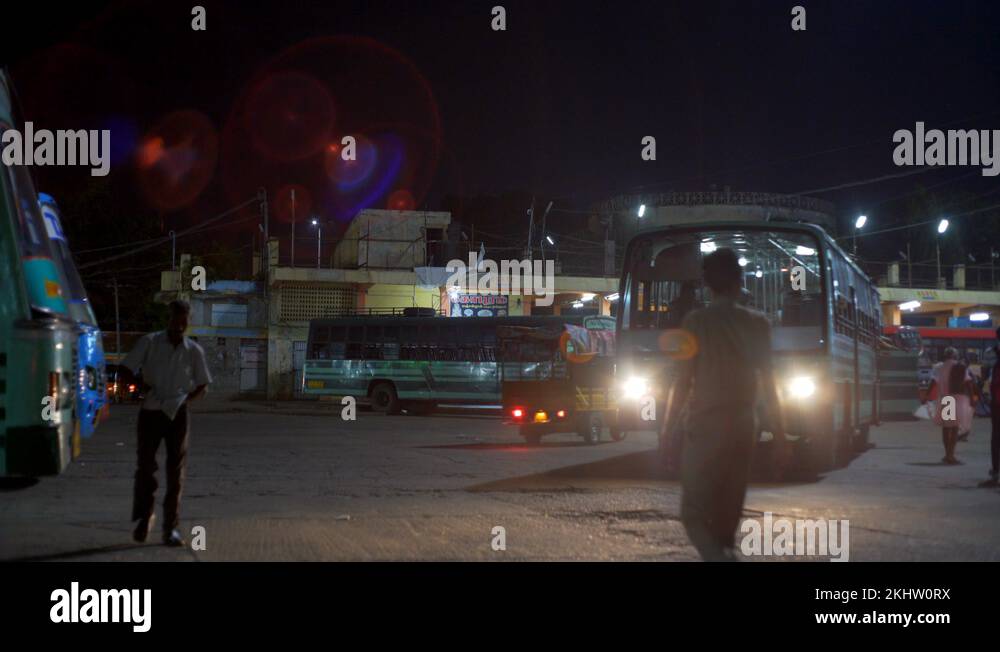 People walk around central bus station at night, public transportation ...