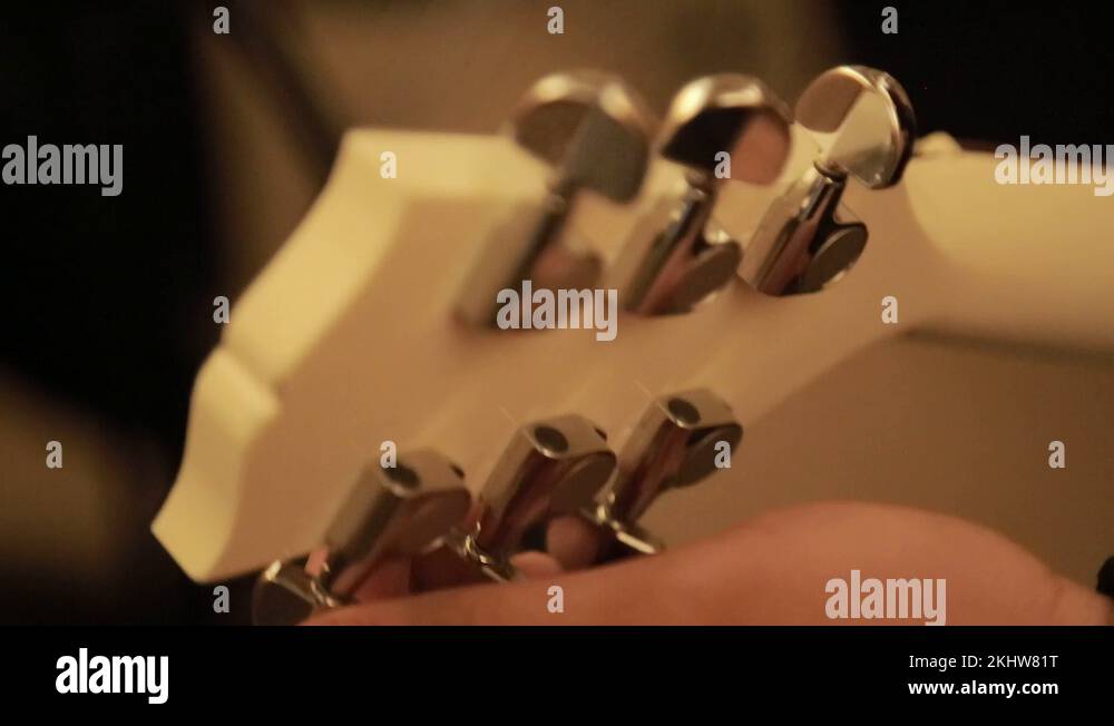 A man tuning his electric guitar Stock Video Footage - Alamy