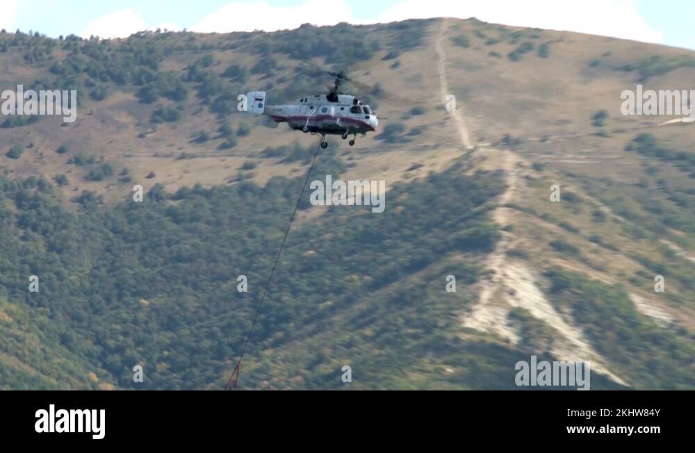 Helicopter Ka-32 demonstrates fire extinguishing over waters of ...