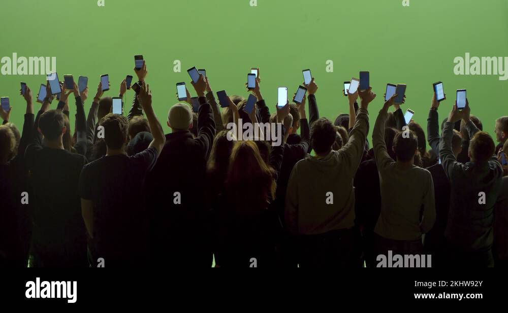 GREEN SCREEN Back view huge crowd of people with phones in hands at ...