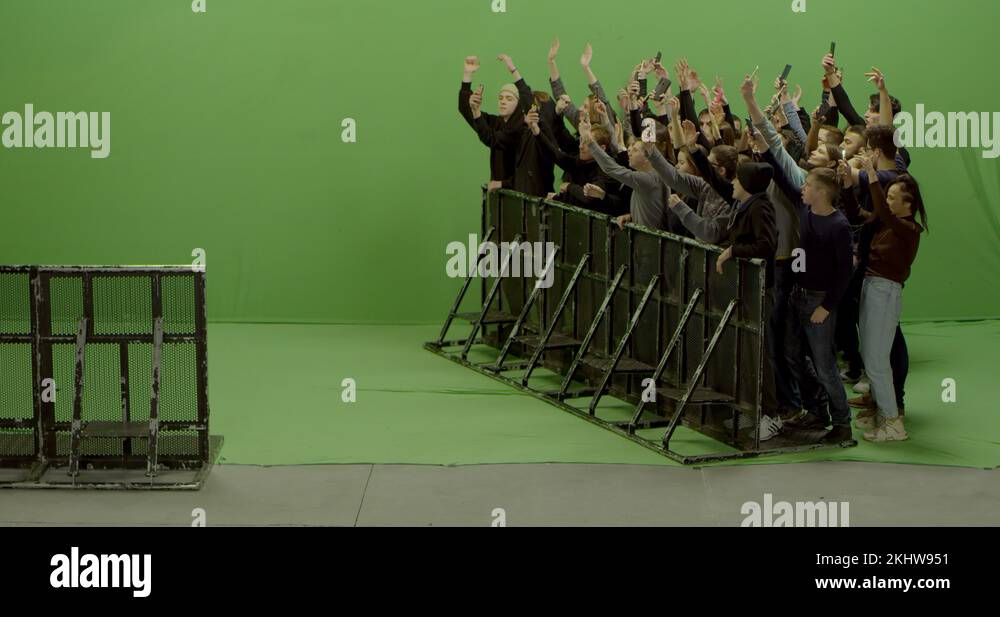 GREEN SCREEN Front view huge crowd dancing and cheering behind control ...