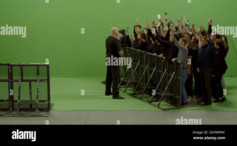 GREEN SCREEN Front view huge crowd dancing and cheering behind control ...