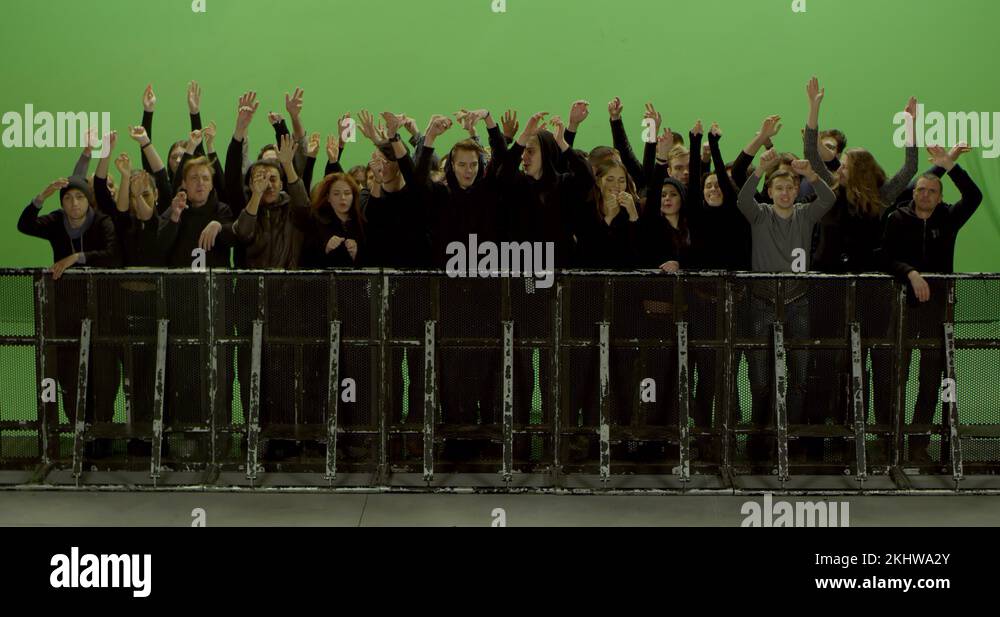 GREEN SCREEN Front view huge crowd dancing and cheering behind control ...