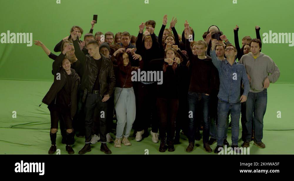 GREEN SCREEN Front view huge crowd jumping and cheering at a concert or ...