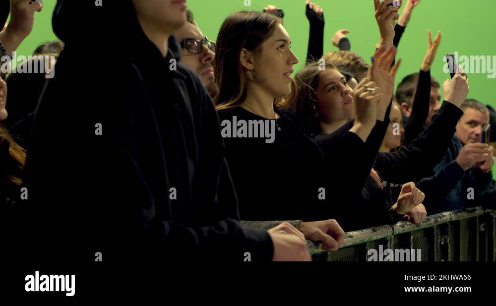 GREEN SCREEN Front view huge crowd dancing and cheering behind control ...