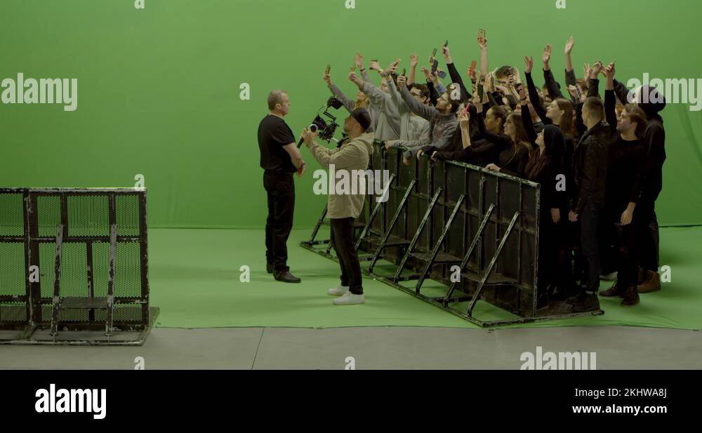 GREEN SCREEN Front view huge crowd dancing and cheering behind control ...