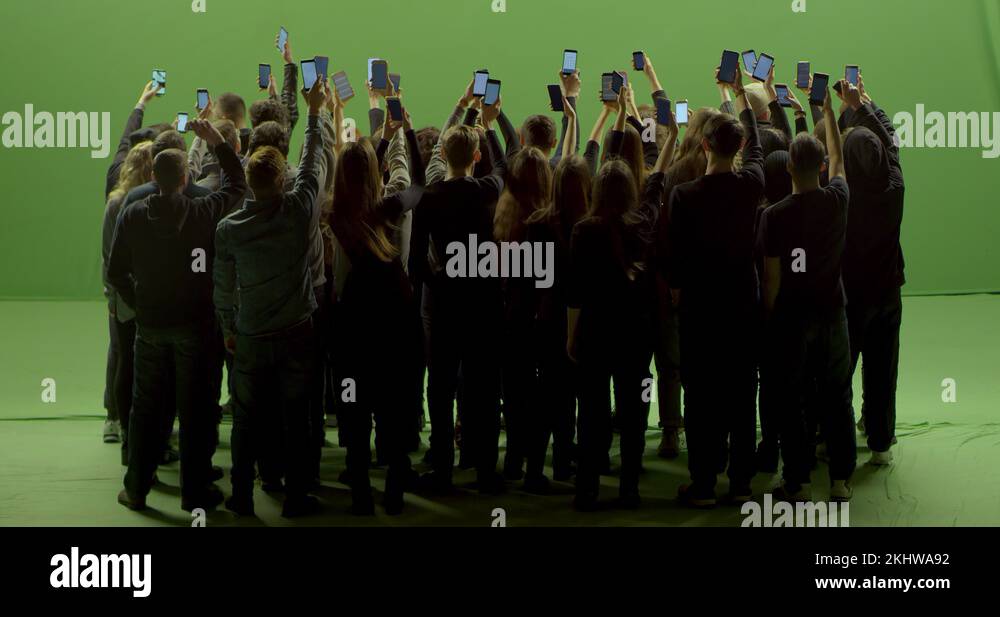 GREEN SCREEN Back view huge crowd of people with phones in hands at ...
