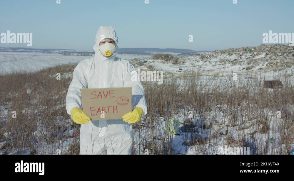 Man wore in protective suit show protest sign "Save Earth" at plastic ...
