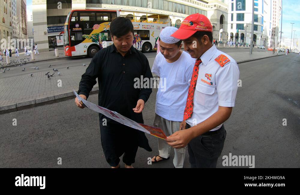 Tourist bus driver shows map to Chinese Muslim pilgrims in Medina ...