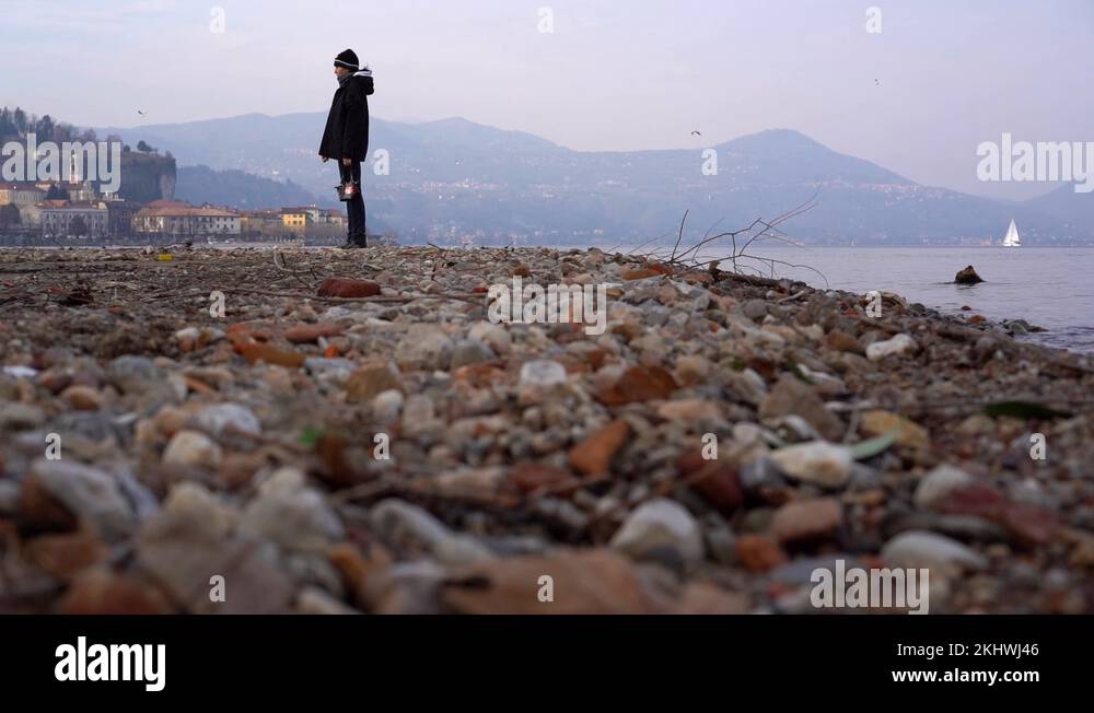Ground level low angle walk towards mother and child girl on lakeside ...