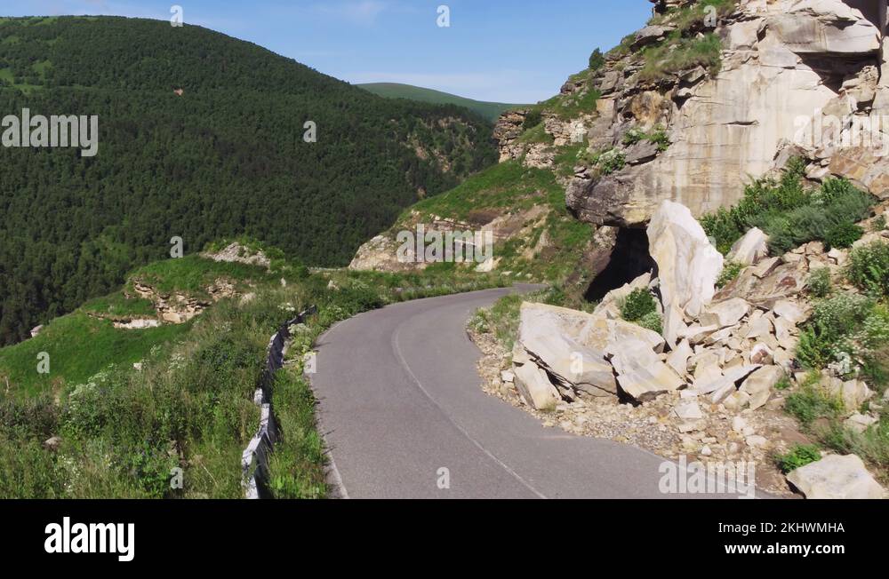 Empty serpentine road over cliff with fence asphalt winding freeway ...