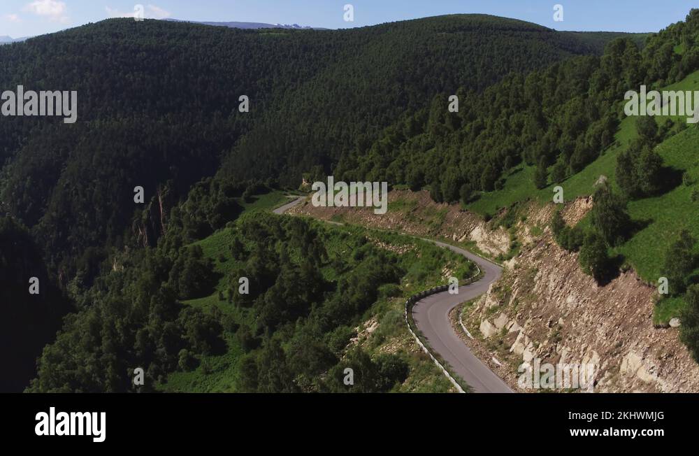 Empty serpentine road over cliff with fence asphalt winding freeway ...