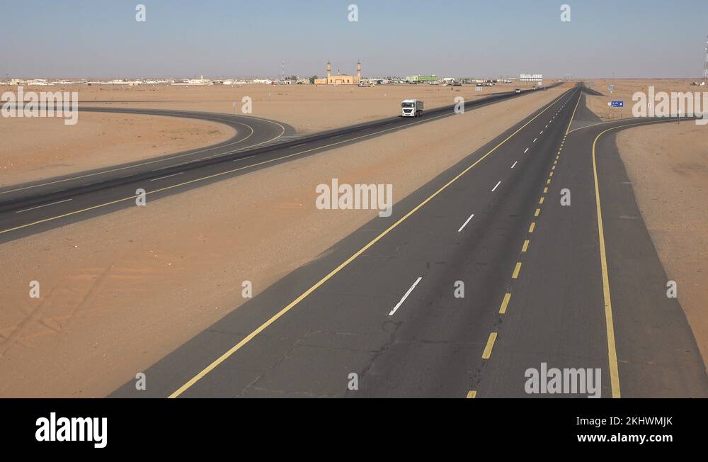 Cargo trucks and cars drive over quiet highway in Saudi Arabia Stock ...
