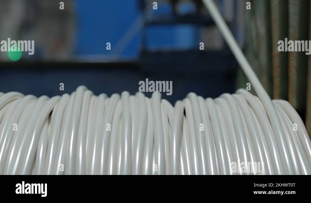 Winding cable on a rotating coil. Production of electric cable Stock ...