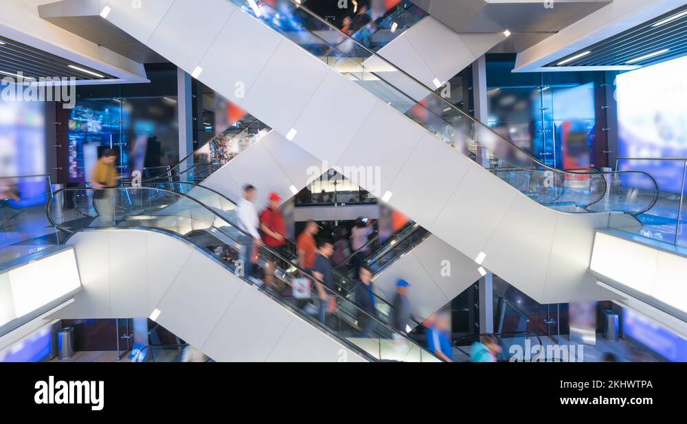 Shopping mall crowd of people on escalators. Consumption concept. Rush ...