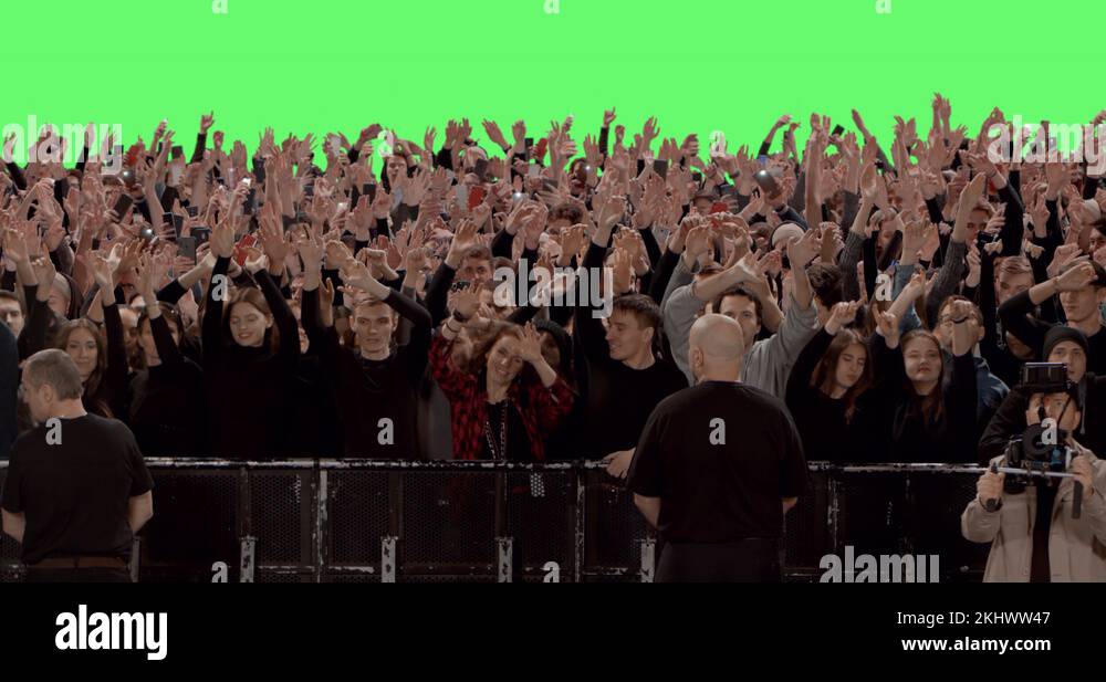 GREEN SCREEN Front view huge crowd dancing and cheering behind control ...