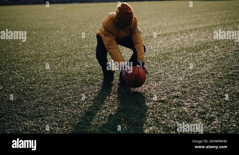 A boy plays with a ball. He throws it up with his hands and feet. Slow ...