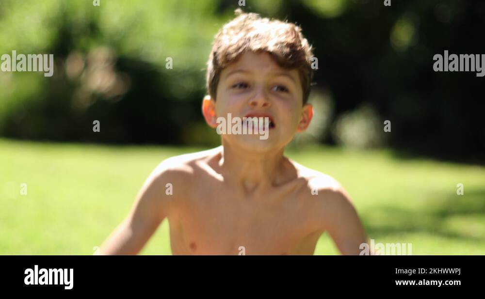 Child boy screaming from top of his lungs in slow-motion. Angry kid ...
