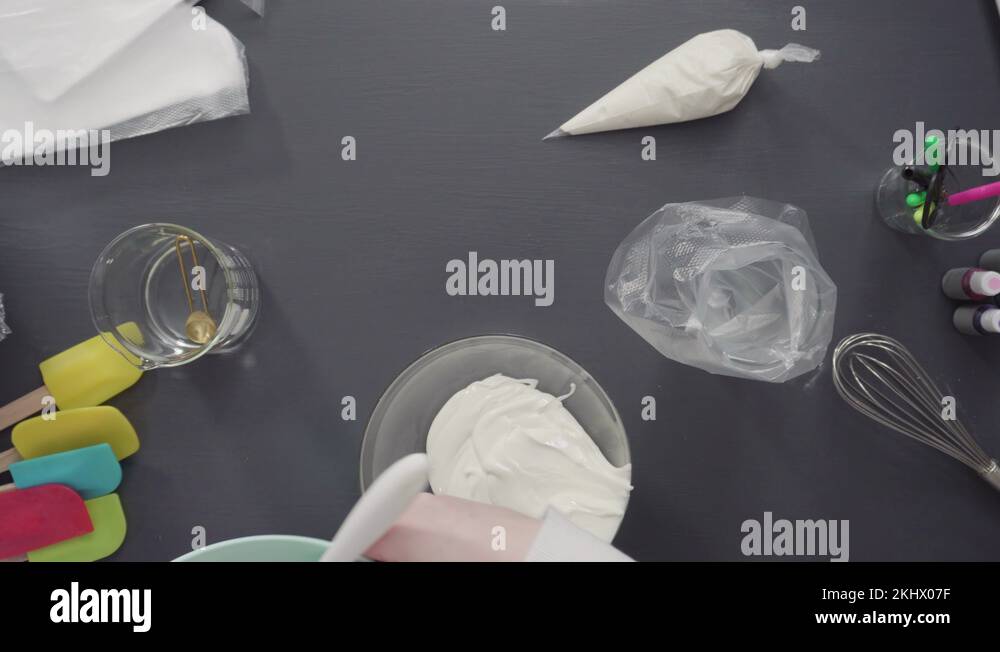 Mixing in food coloring into the royal icing to decorate sugar cookies ...