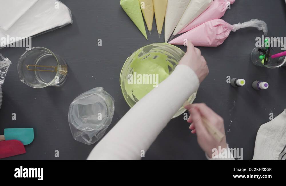 Mixing in food coloring into the royal icing to decorate sugar cookies ...