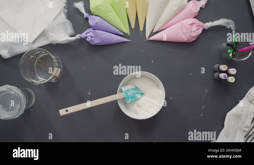 Mixing in food coloring into the royal icing to decorate sugar cookies ...