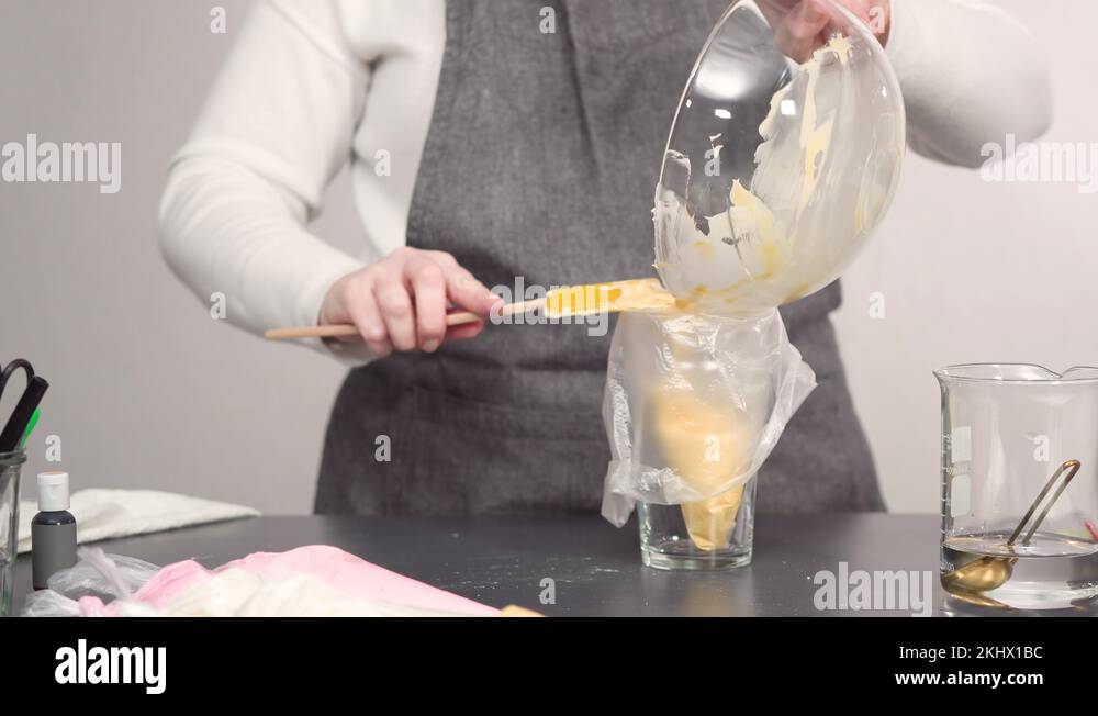 Mixing in food coloring into the royal icing to decorate sugar cookies ...