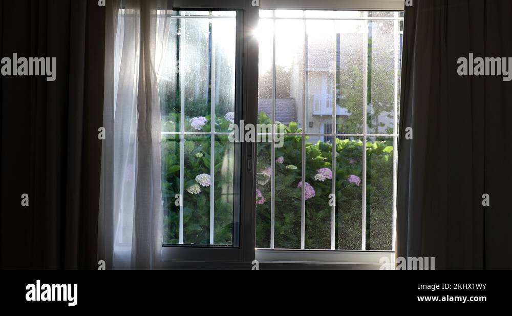 Sunlight lens-flare shining through bedroom window during sunset time ...