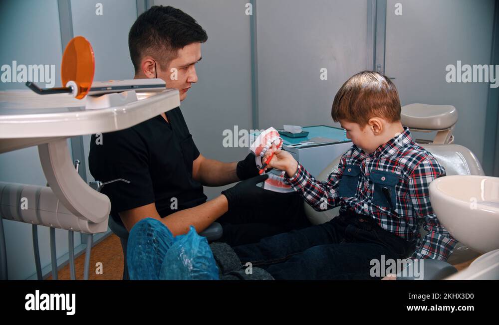 A little boy having a treatment in the modern dentistry - explaining ...