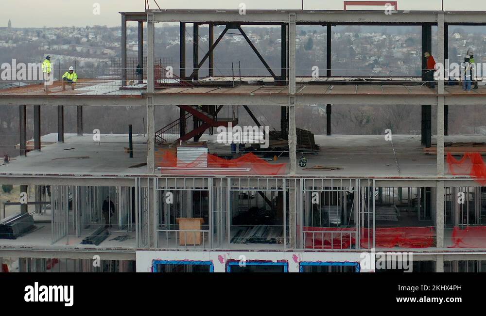 Slow orbiting shot of the top floors of a steel frame building under ...
