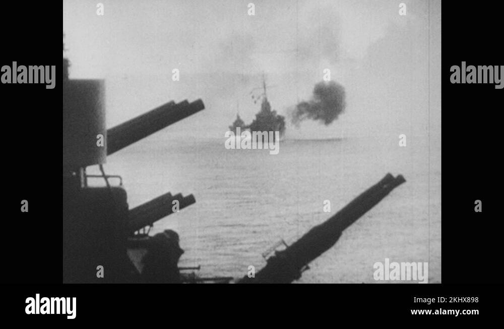 1950s: Battleships fire guns at sea. Guns on battleship fire. Artillery ...