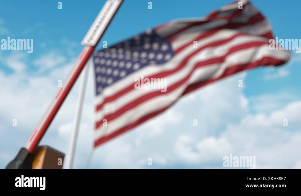 Closing boom barrier with QUARANTINE sign against the American flag ...