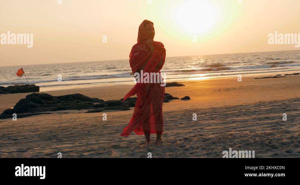 Young women wearing a red saree on the beach goa India.girl in ...
