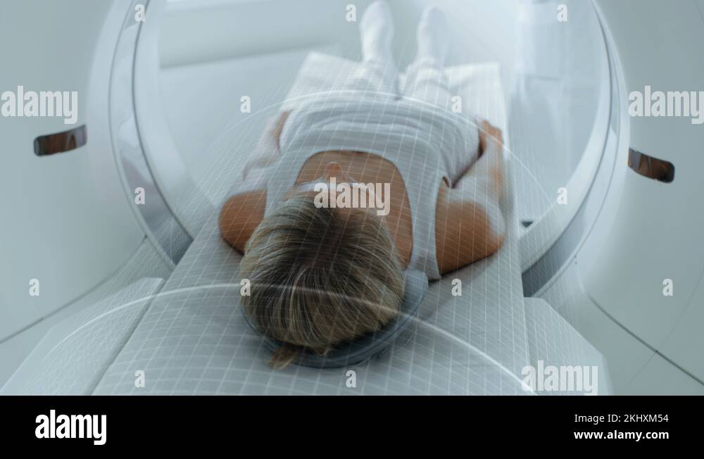 Female Patient Lying on a CT or MRI Scan Bed, Moving Machine Scans Her ...